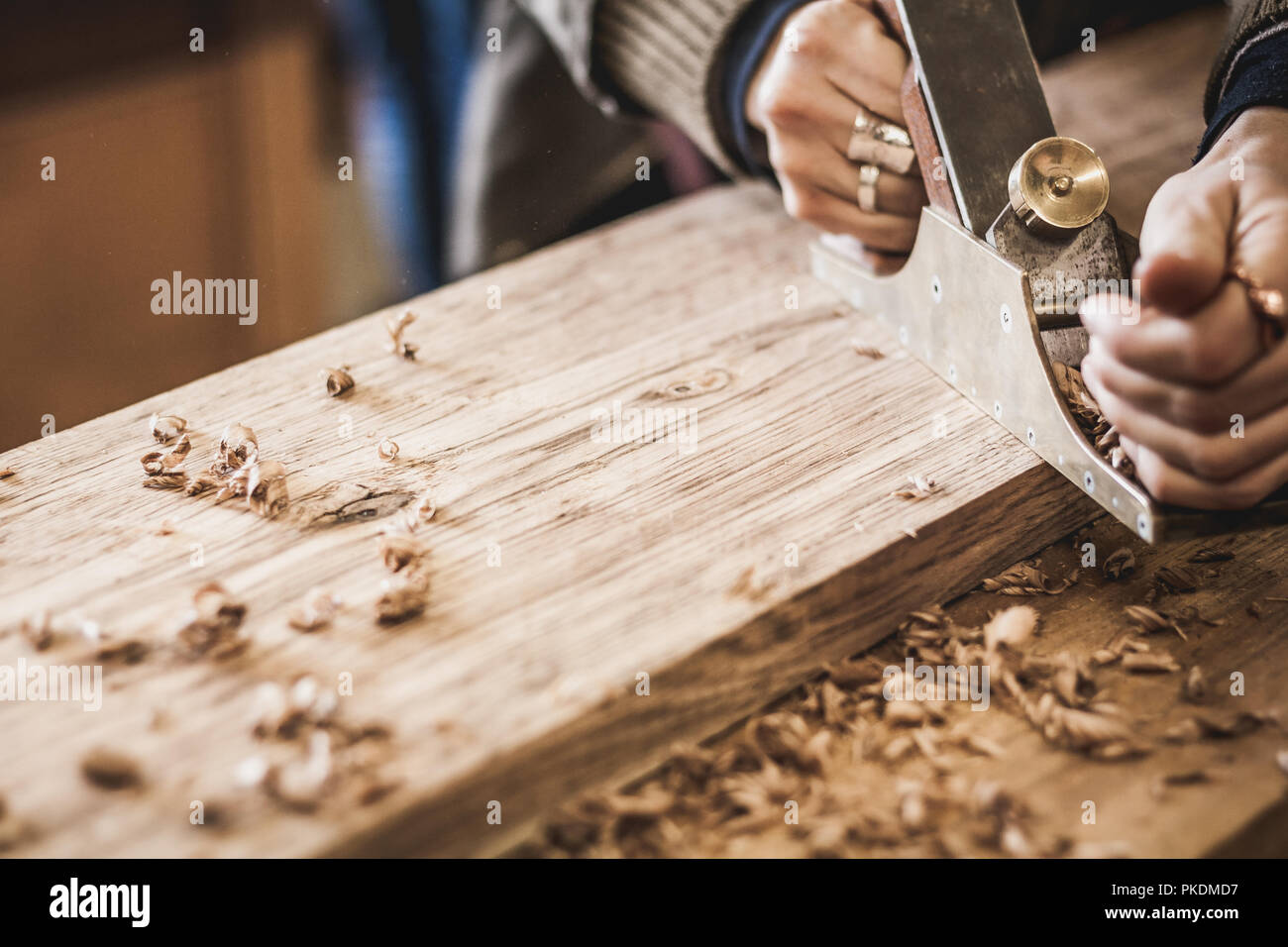 Details of working carpenters while operating a planer. Clear, light ...