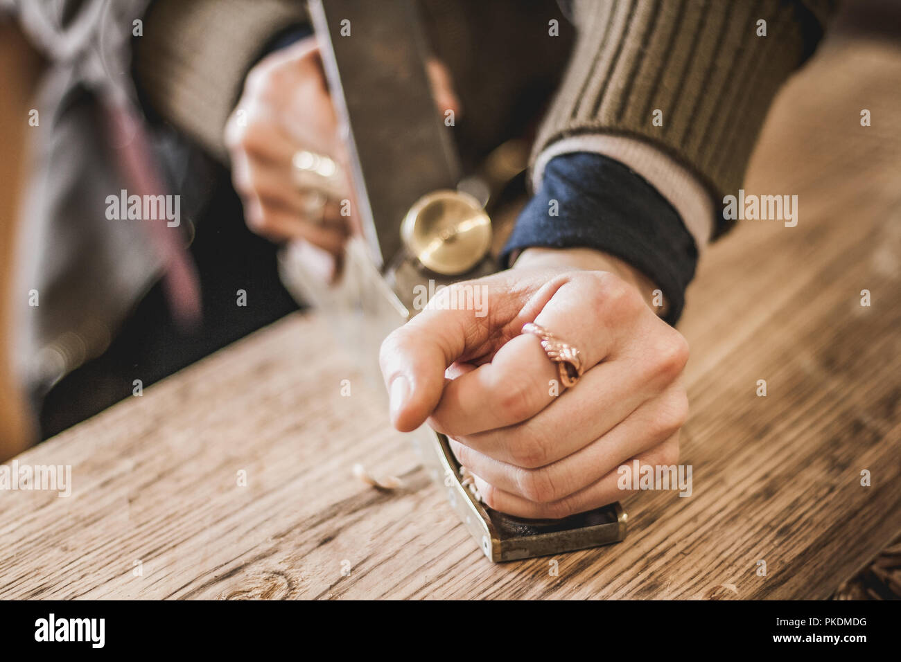 Details of working carpenters while operating a planer. Clear, light ...
