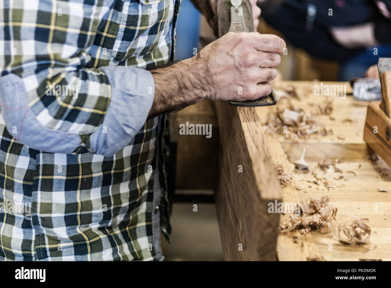 Details of working carpenters while operating a planer. Clear, light ...