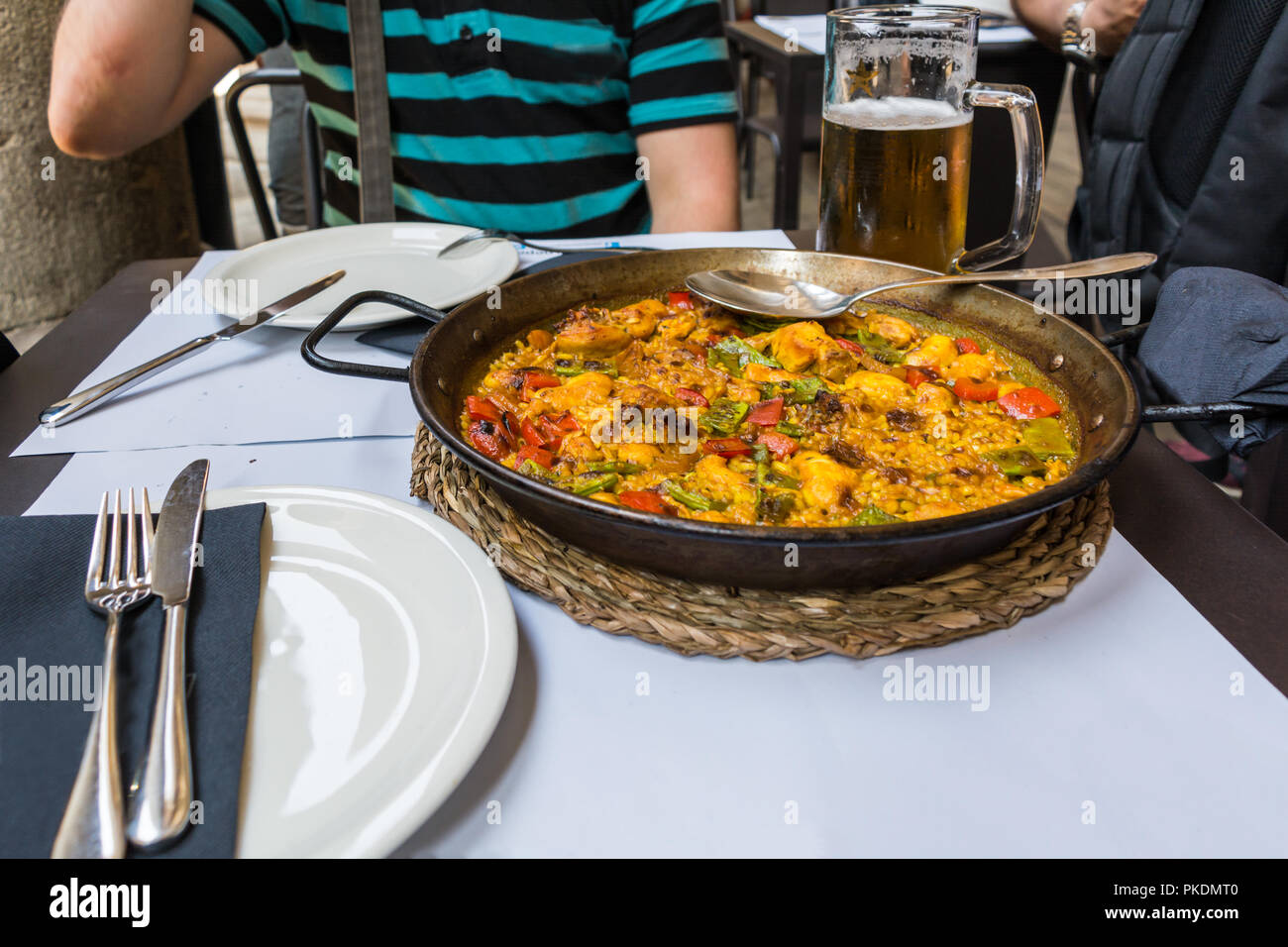 Traditional Spanish dish - chicken paella served in frying pan on white ...
