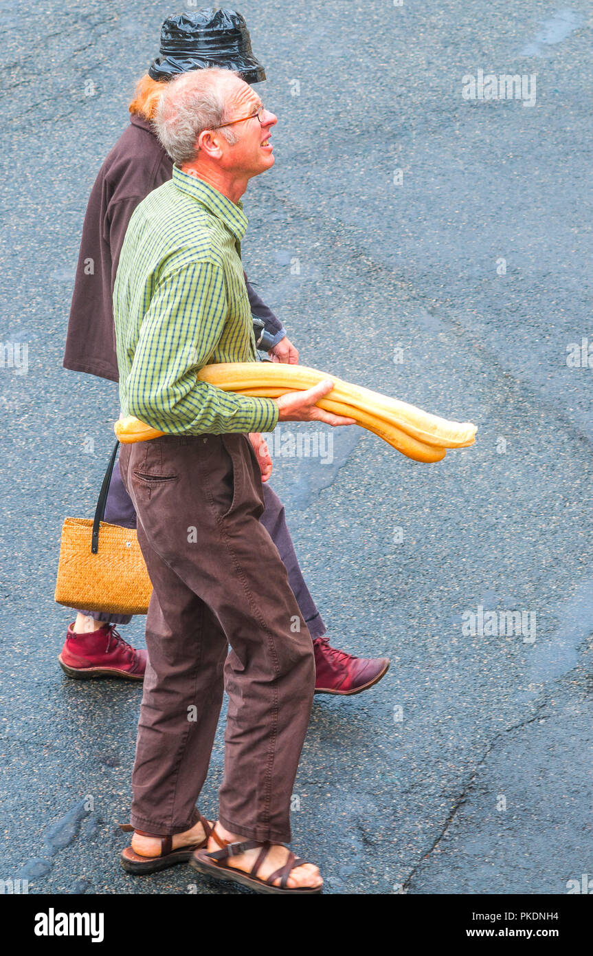 Couple walking, man with baguettes under arm - France Stock Photo - Alamy
