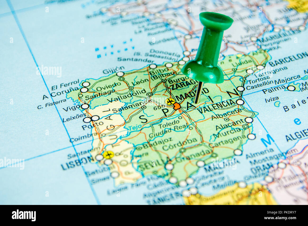 closeup of draw-pin stick into real map, travelling to Spain ...