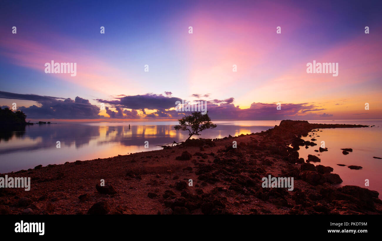 Sunrise over North Cebu Province Fisherman fishing in the Sea with a ...