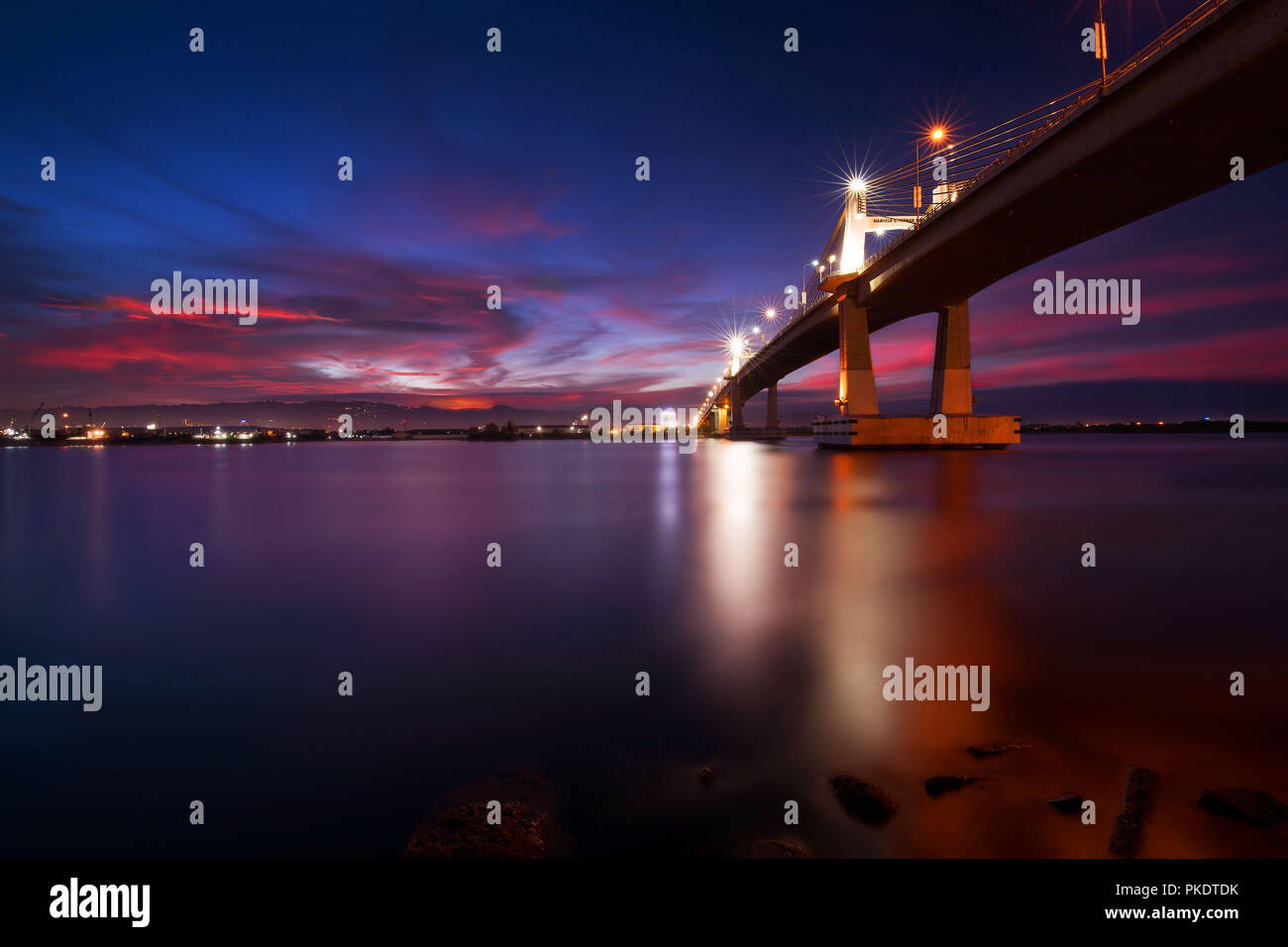 Mactan Bridge at Night in sunset dusk blue hour, cloudscape in dramatic ...