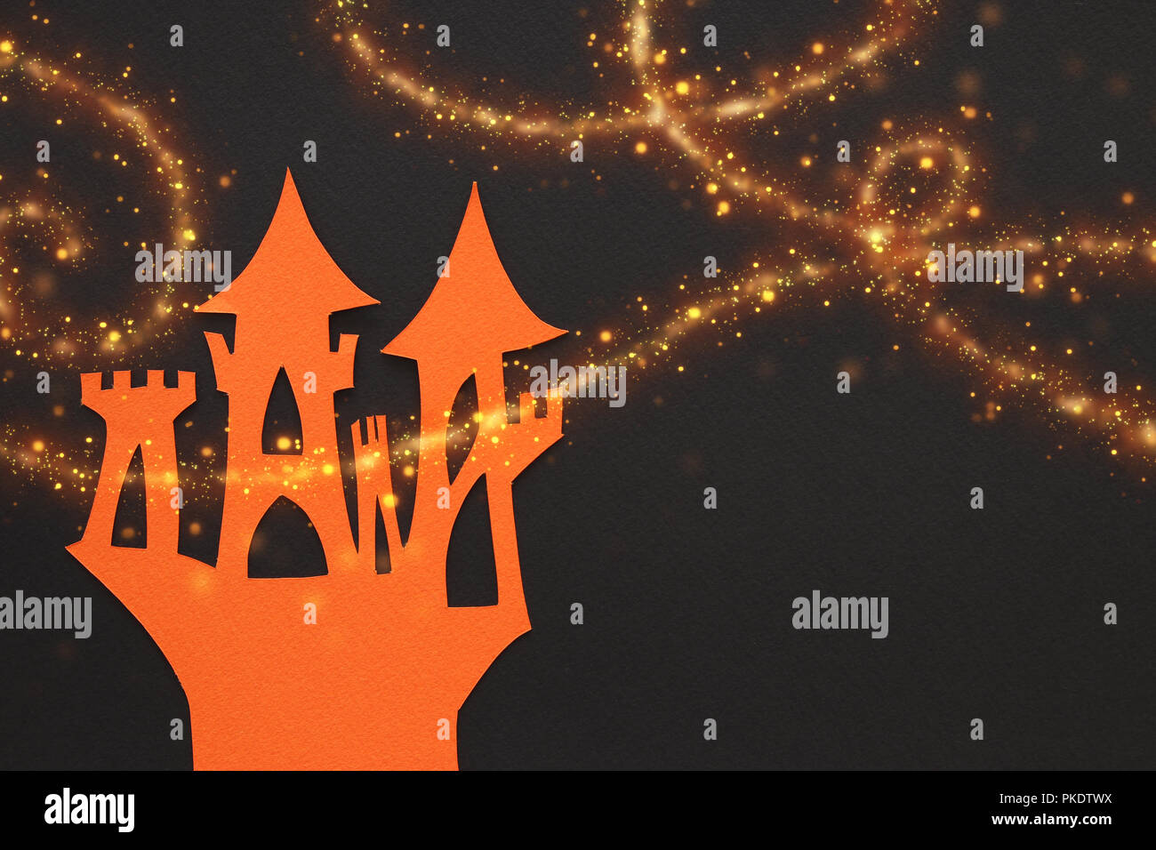 Castle over black paper background and glowing golden lights Stock ...