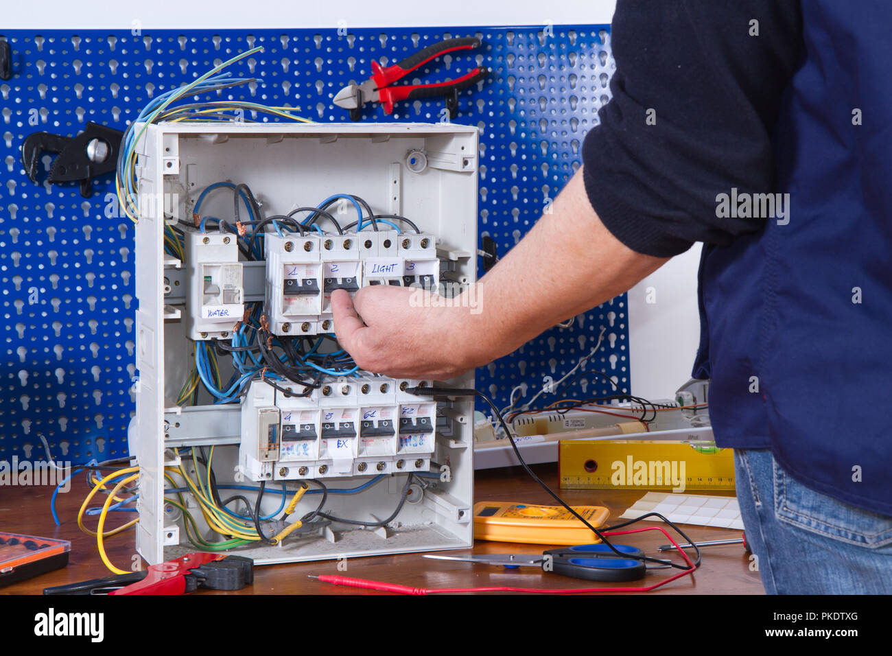 electrician at work with an appliance Stock Photo - Alamy