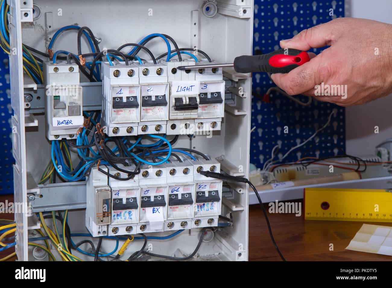electrician at work with an appliance Stock Photo - Alamy