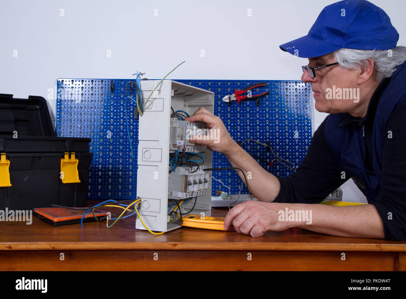 electrician at work with an appliance Stock Photo - Alamy