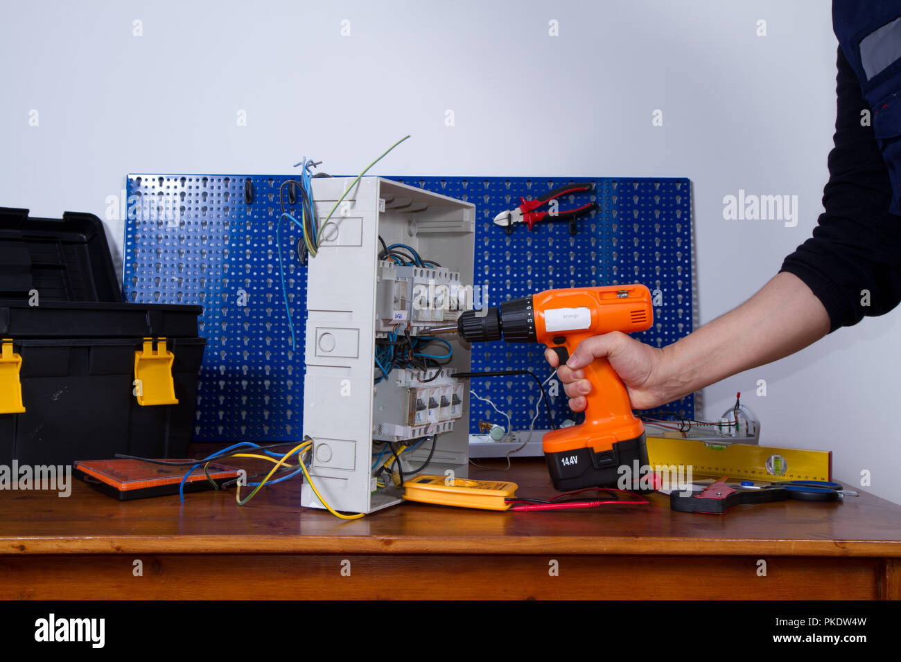 electrician at work with an appliance Stock Photo - Alamy