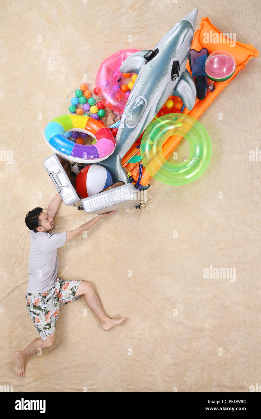 The young man held a box of toys Stock Photo - Alamy