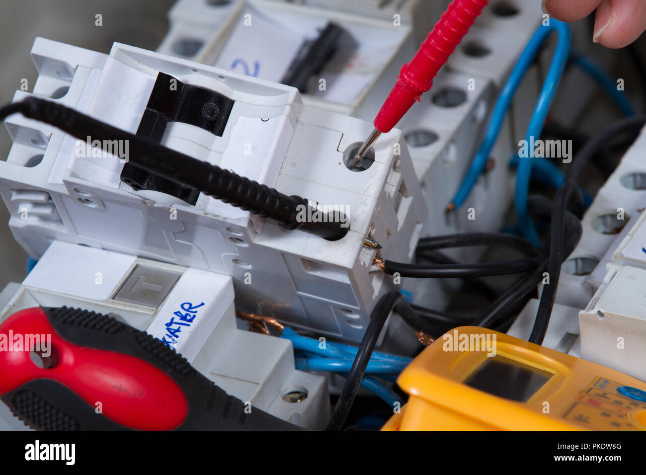 electrician at work with an appliance Stock Photo - Alamy