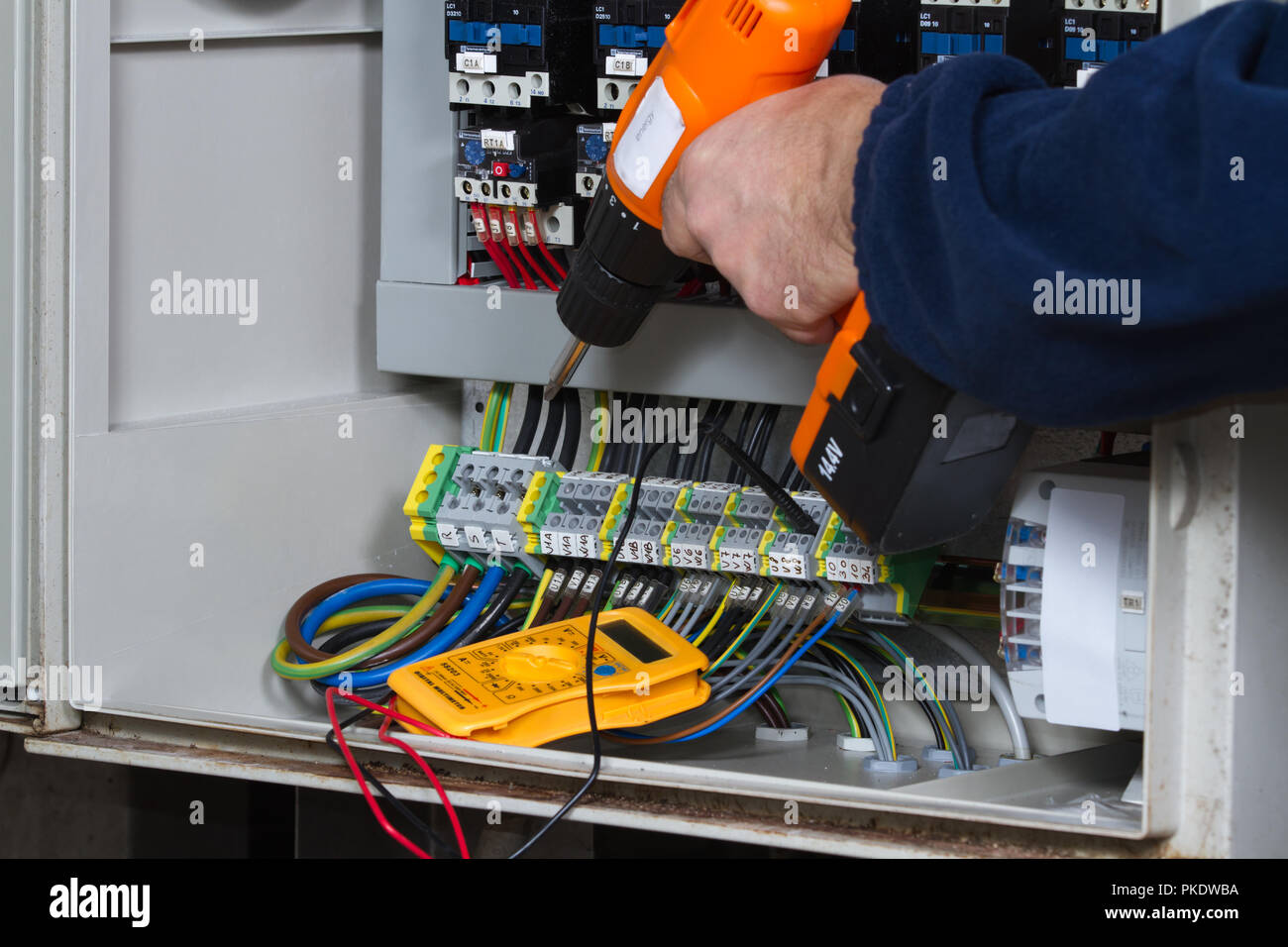 electrician at work with an electric panel Stock Photo - Alamy