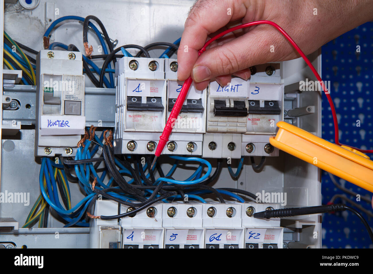 electrician at work with an appliance Stock Photo - Alamy