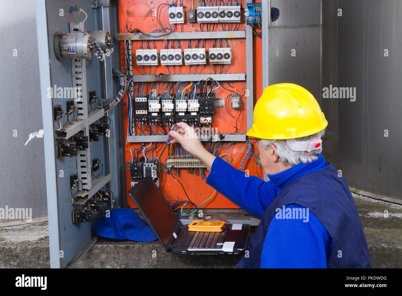electrician at work with an electric panel Stock Photo - Alamy