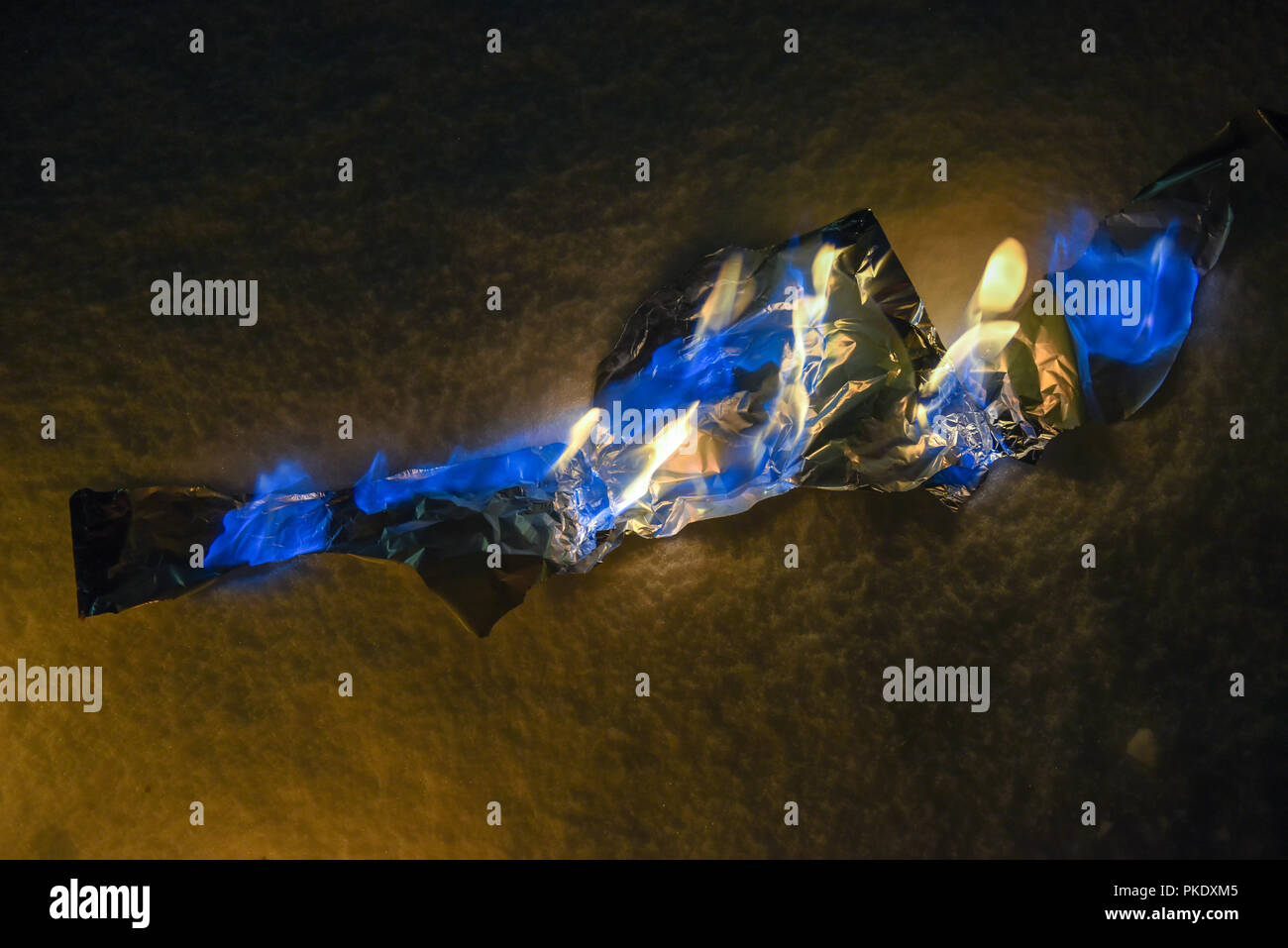 Burning aluminium sheet on the Snow Stock Photo - Alamy