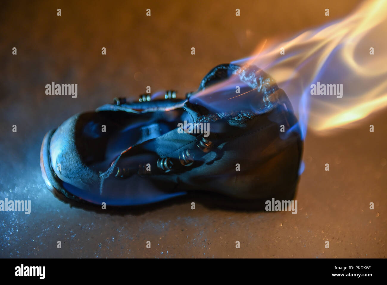 Burning old shoe at night on the Snow Stock Photo - Alamy