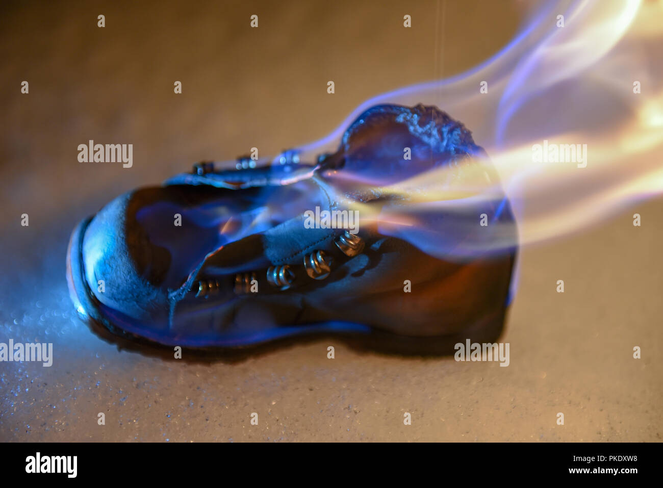 Burning old shoe at night on the Snow Stock Photo - Alamy