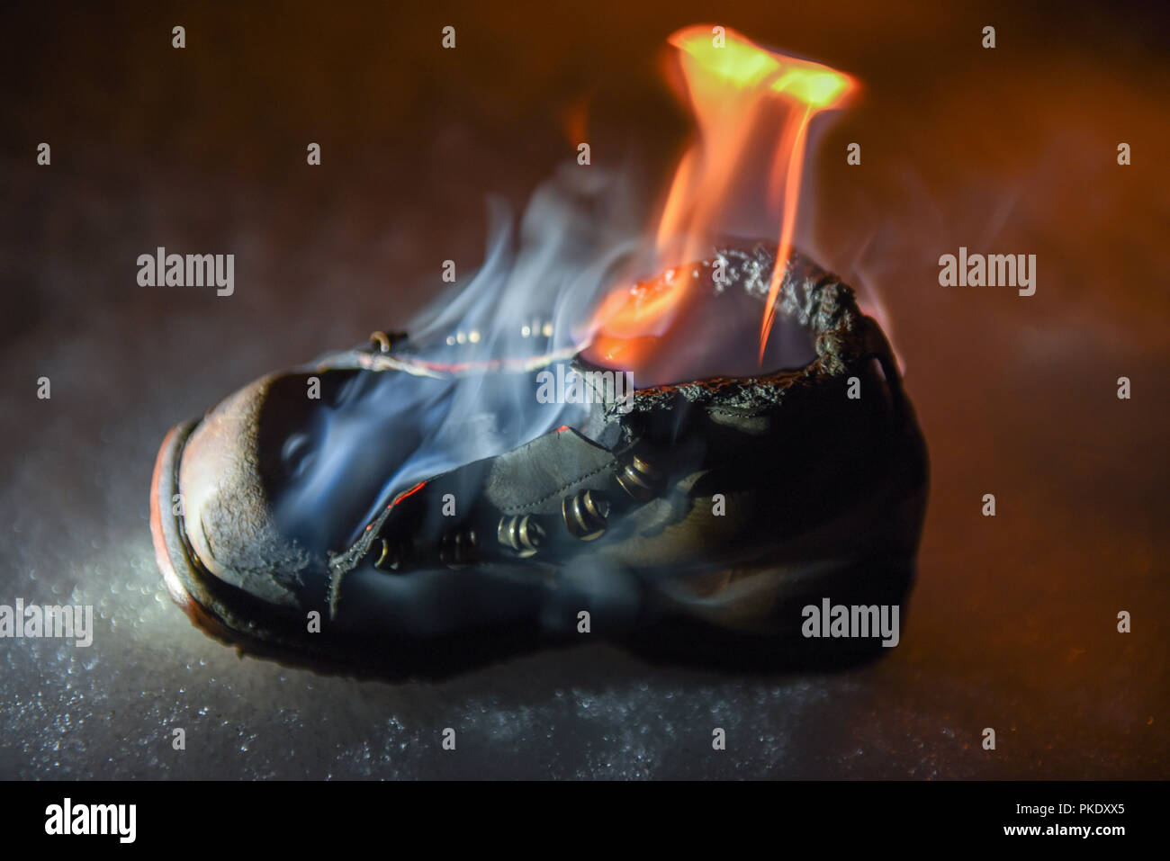 Burning old shoe at night on the Snow Stock Photo - Alamy