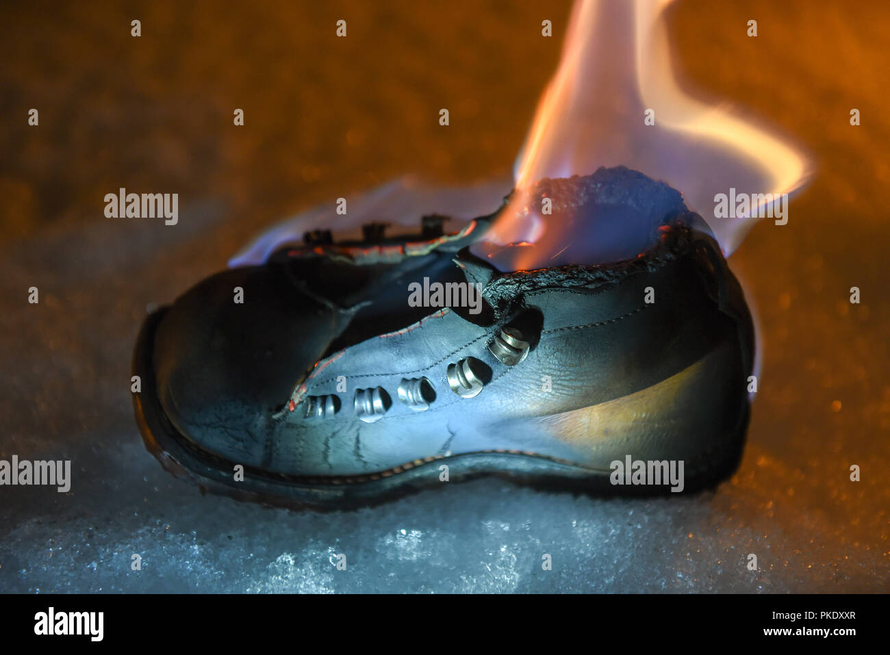 Burning old shoe at night on the Snow Stock Photo - Alamy