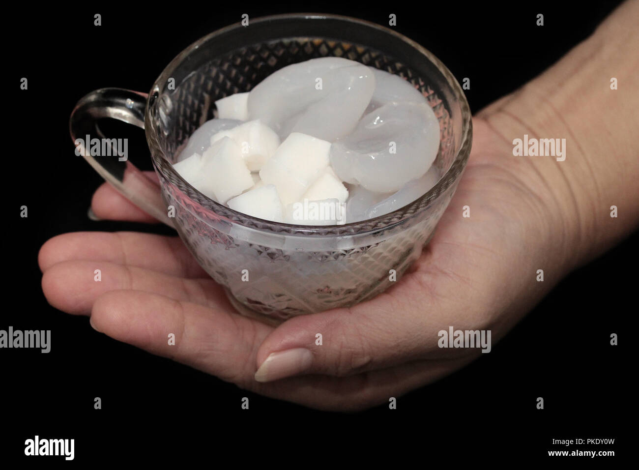 A glass of nipa palm fruit and macapuno coconut ,gelatinous coconut, in ...