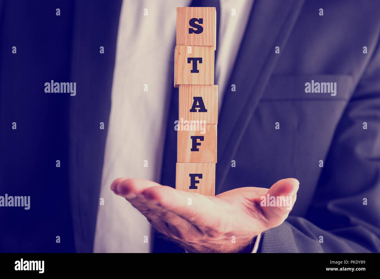 Closeup of businessman hand balancing five wooden cubes spelling the ...