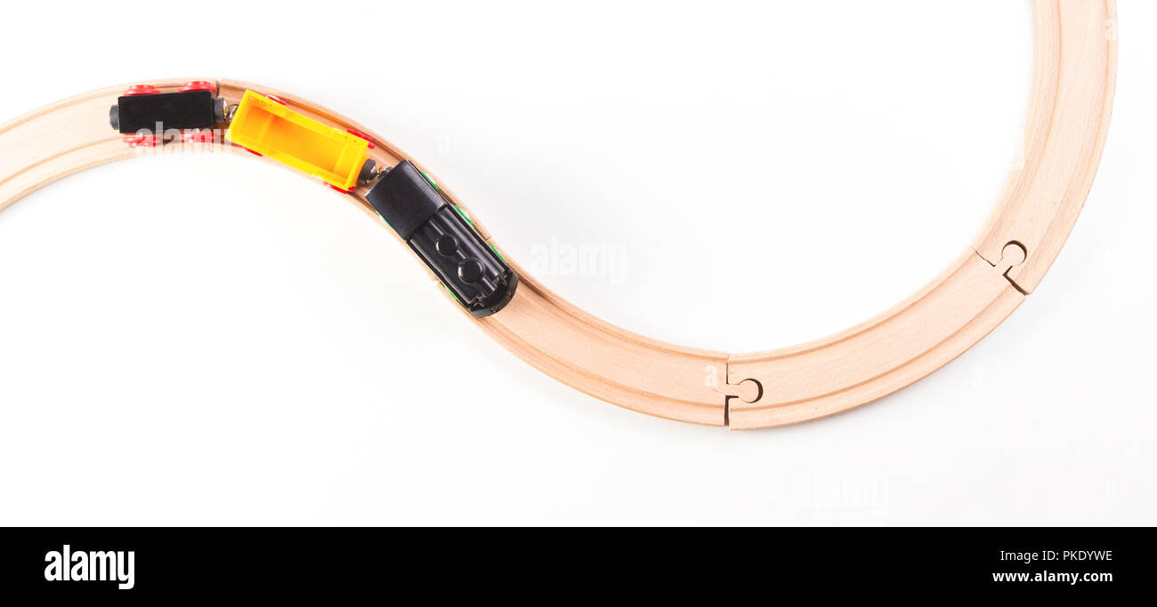Toy train with curved wooden railways on white background. Top view ...