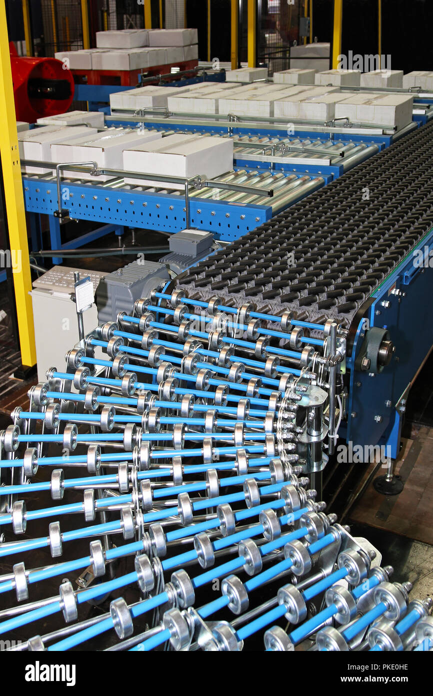 Conveyor rollers at box packing line in factory Stock Photo - Alamy