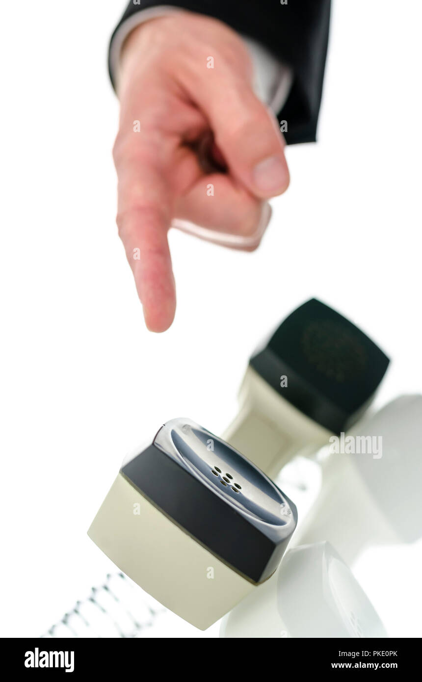 Closeup of business man hand pointing at telephone receiver. Isolated ...