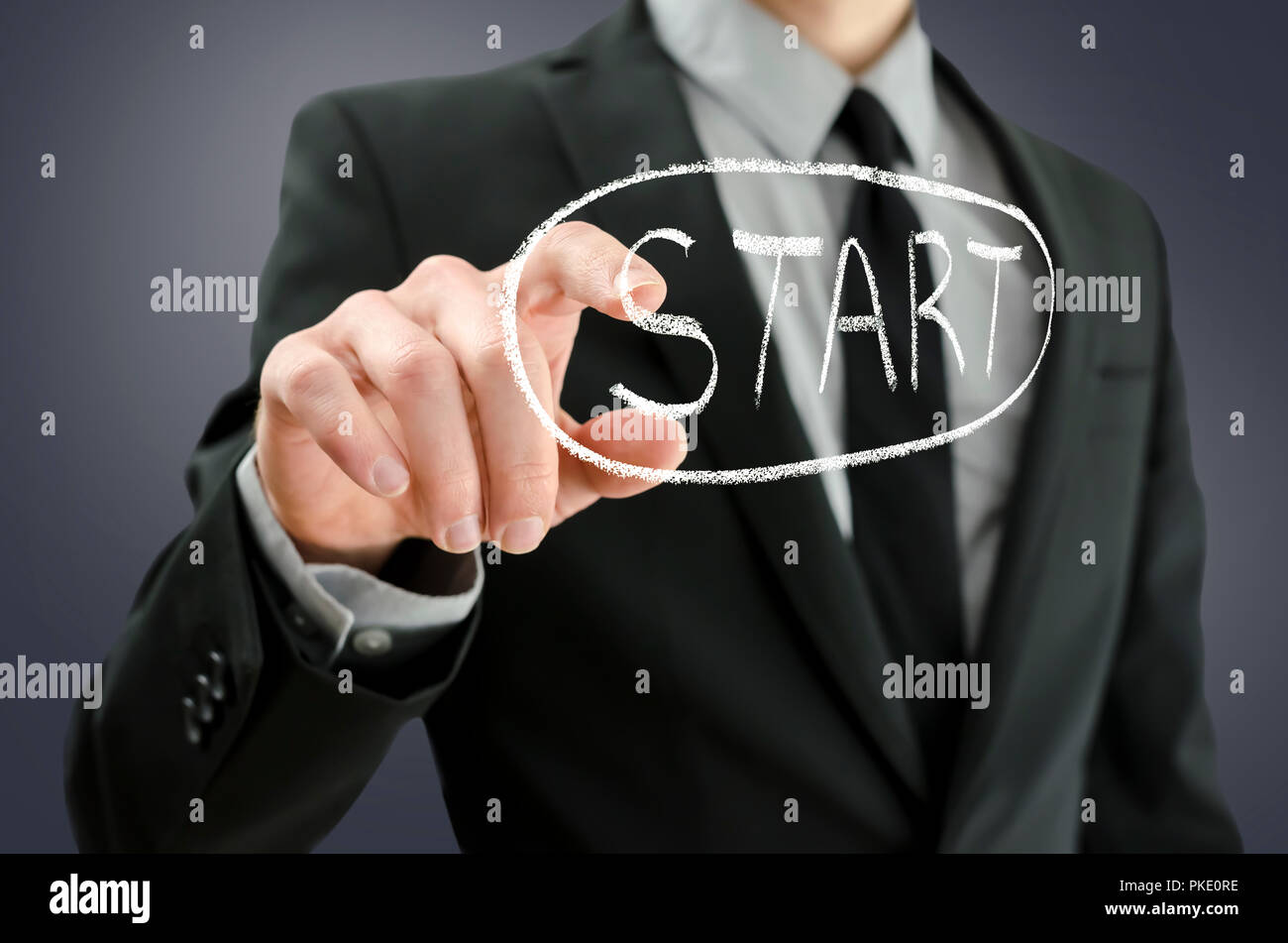 Business man pressing start button on a virtual board Stock Photo - Alamy