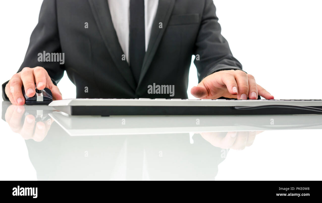 Front view of business man working on computer at his white office desk ...