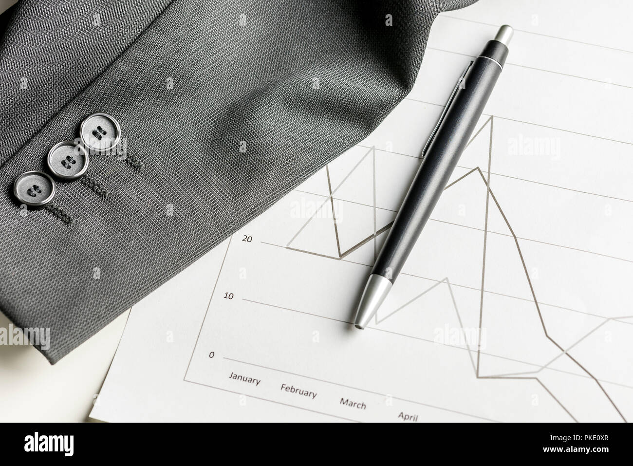 Business setting with pen, financial report and fancy suit Stock Photo ...