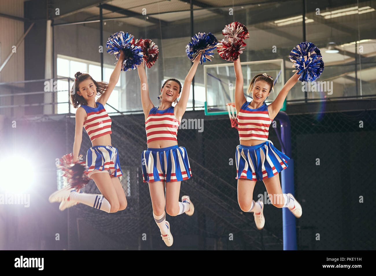 Young female cheerleading Stock Photo - Alamy