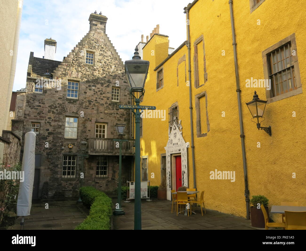 The exterior of the Museum of Edinburgh has a striking yellow render ...