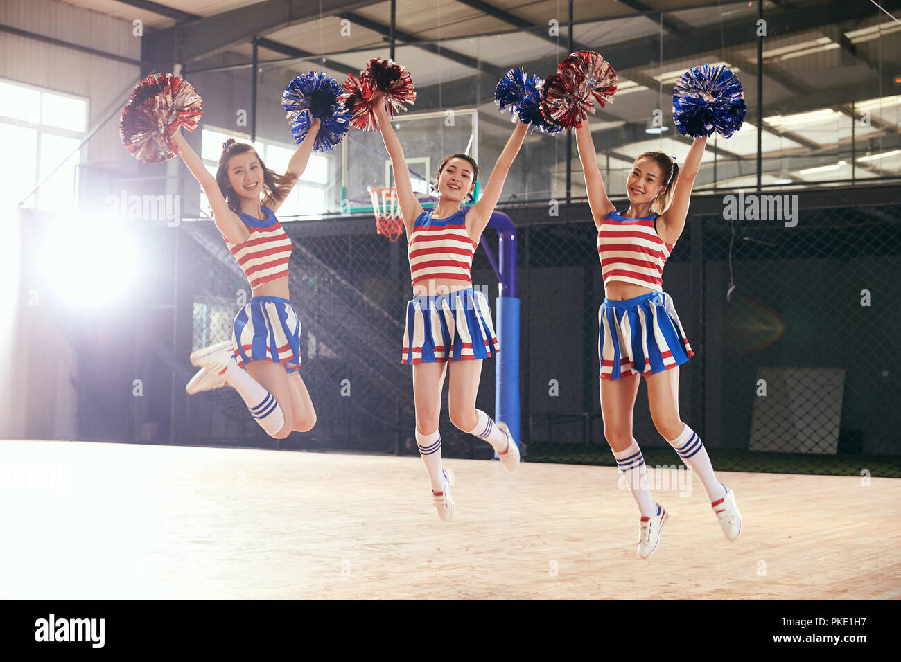 Young female cheerleading Stock Photo - Alamy