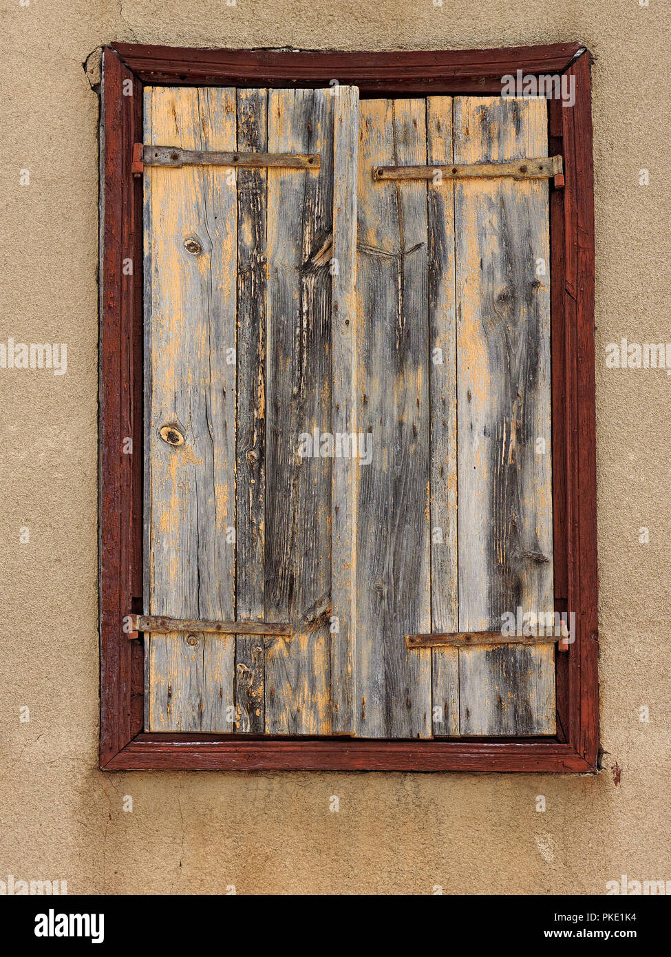 Rustic wooden shuttered window in neglected run down building in the ...