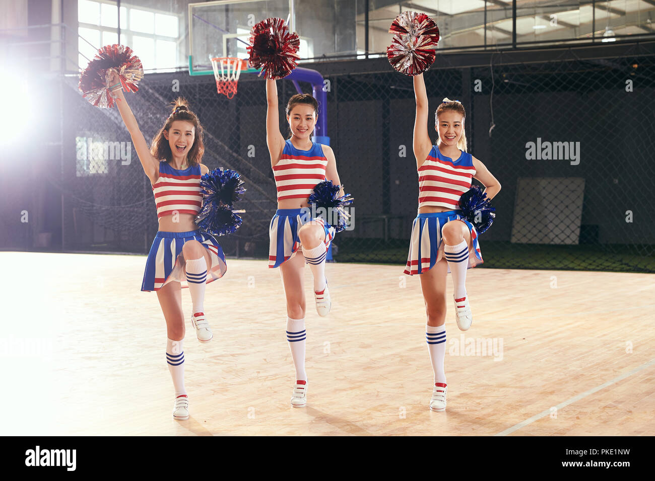 Young female cheerleading Stock Photo - Alamy
