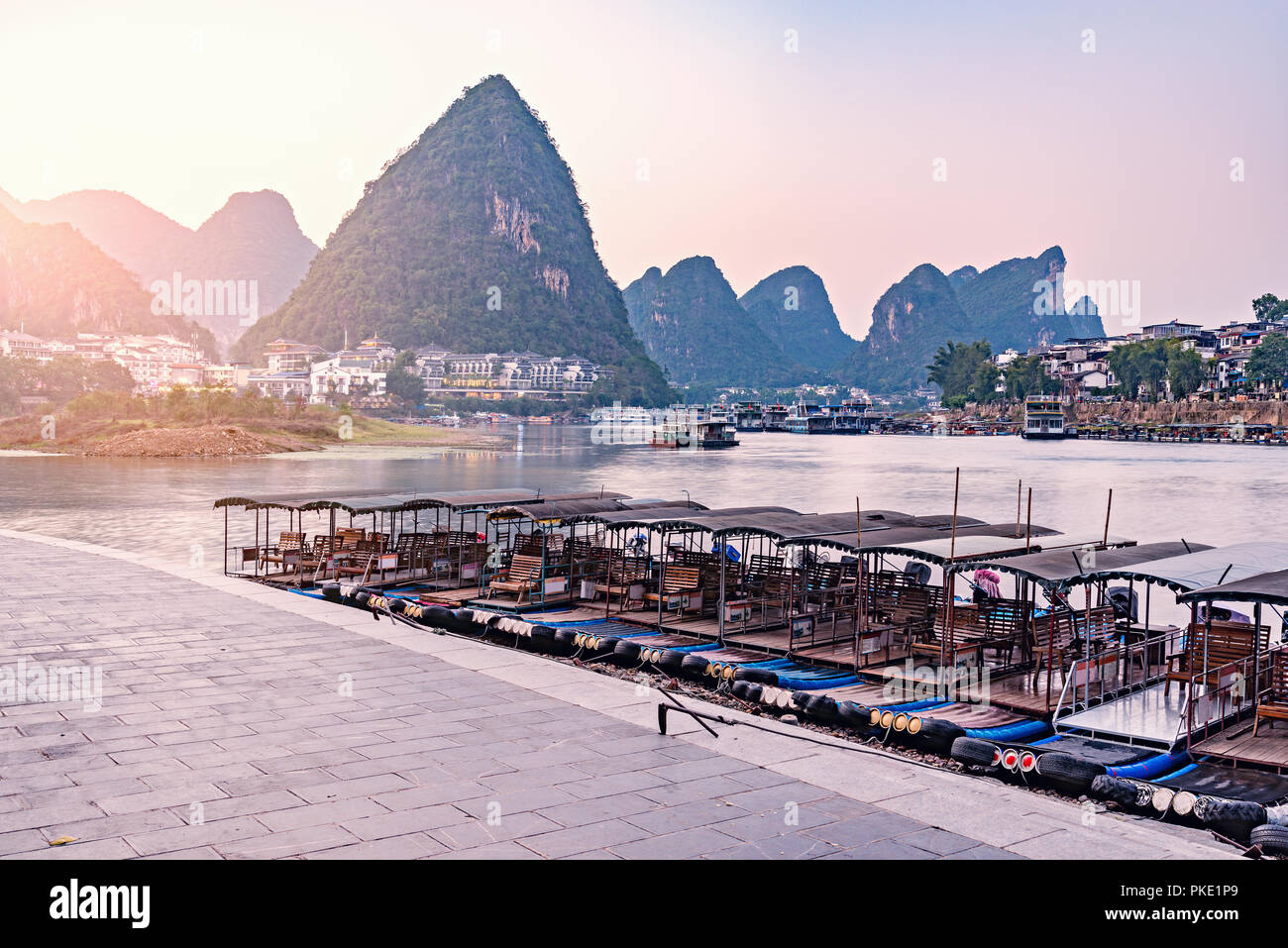 Boats by the embankment at evening time. Yangshuo. China Stock Photo ...