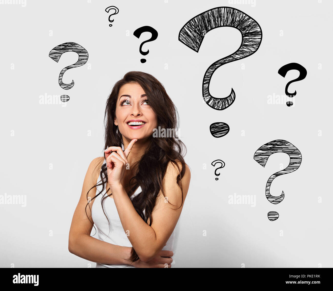 Thinking smiling with hand under the face woman with many drawing ...