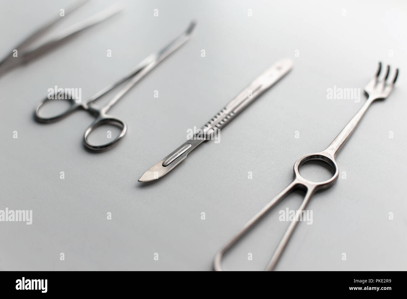 Steel scalpel with medical tools on a white table Stock Photo - Alamy