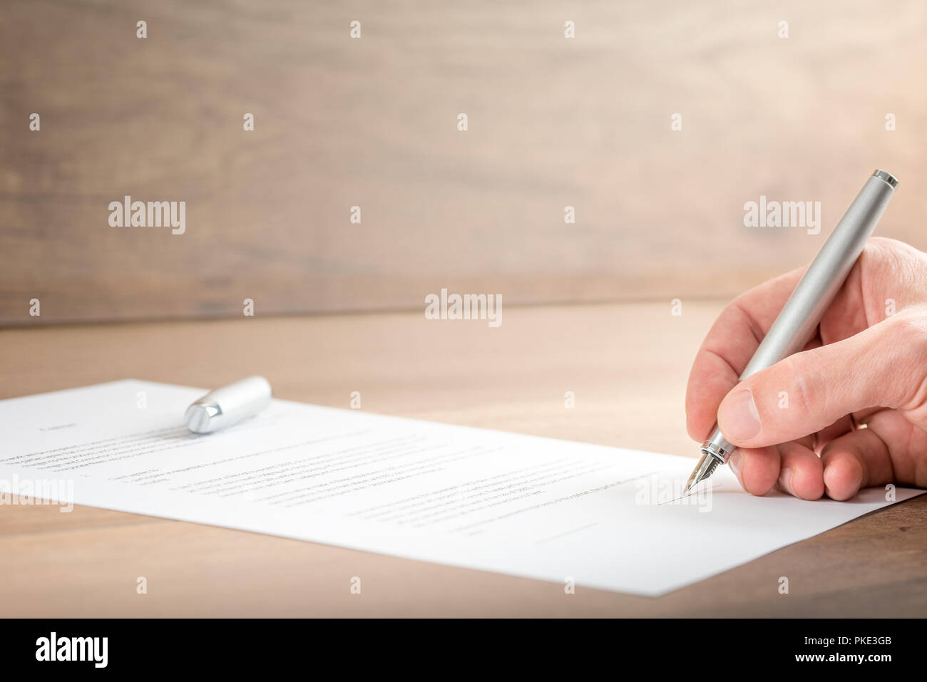 Close up Hand of a Businessman Signing a Contract Document on Top of a ...