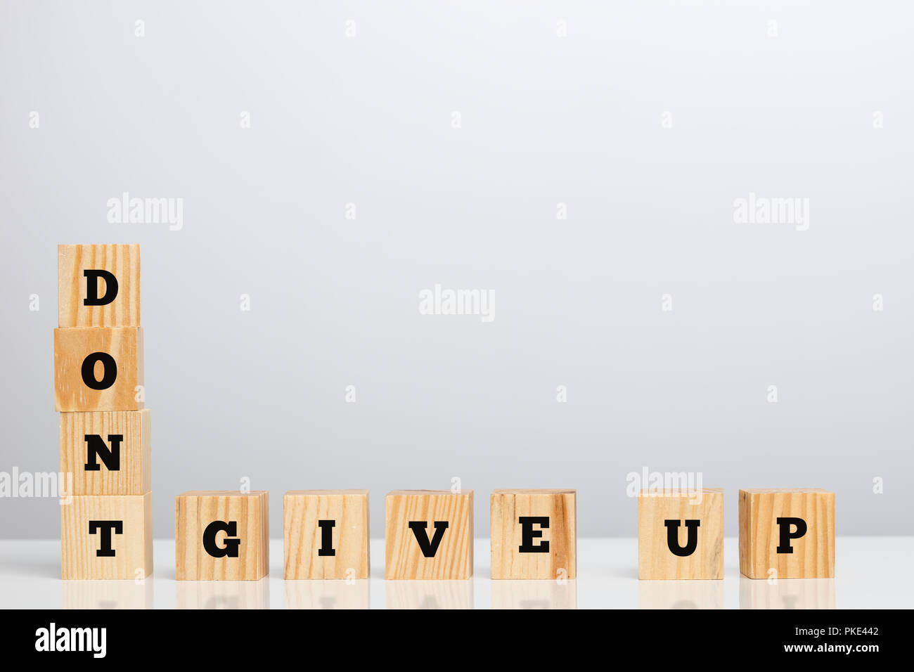 Don't Give Up Spelled in Letter Blocks on Studio Grey Background Stock ...