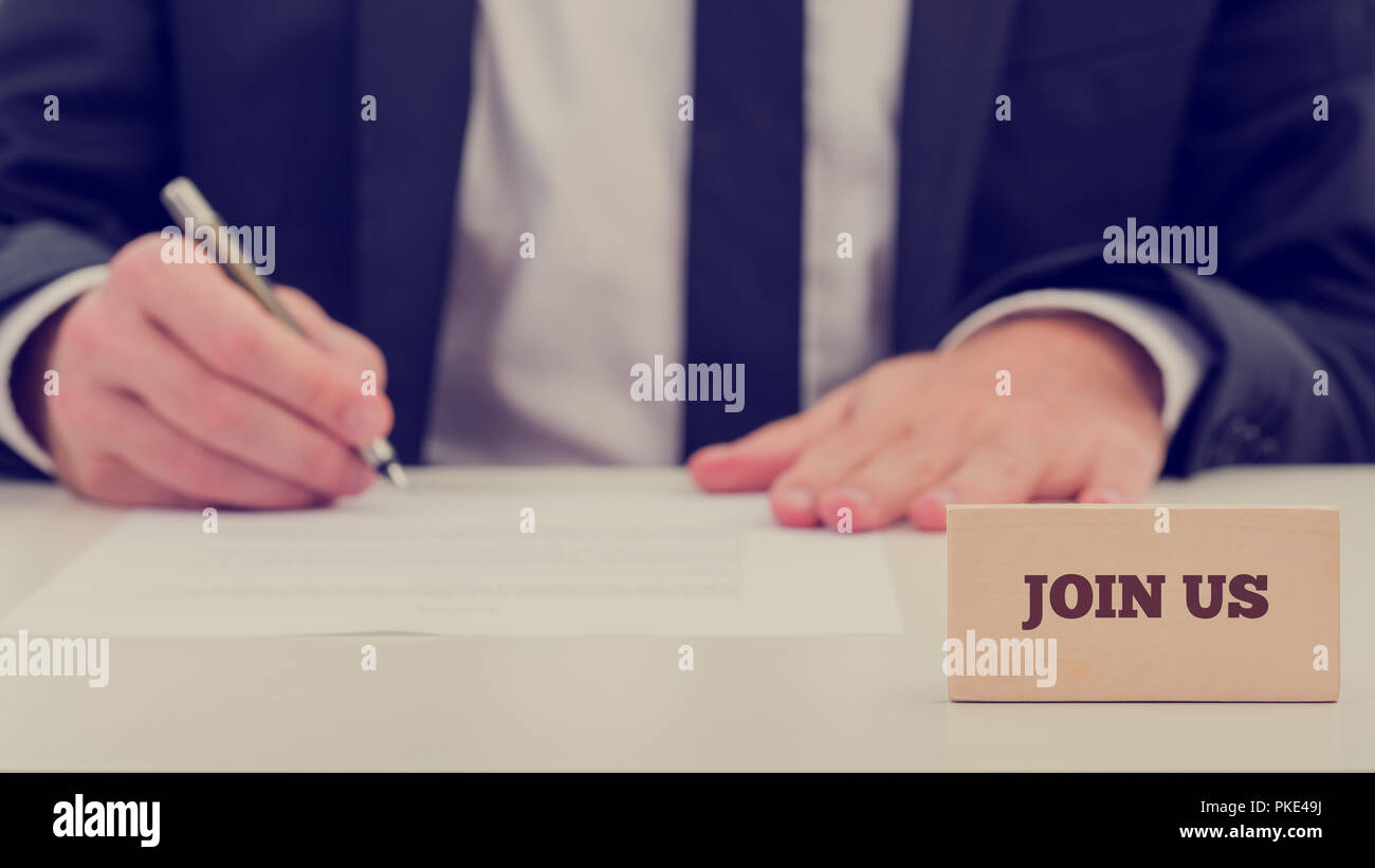 Join Us concept with a businessman sitting completing a job application ...