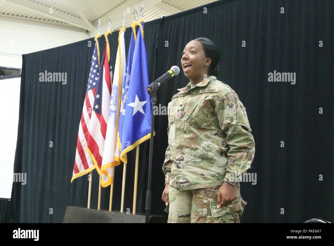 Spc. CeCe Benson, a soloist with the 122nd Army Band, sings the ...