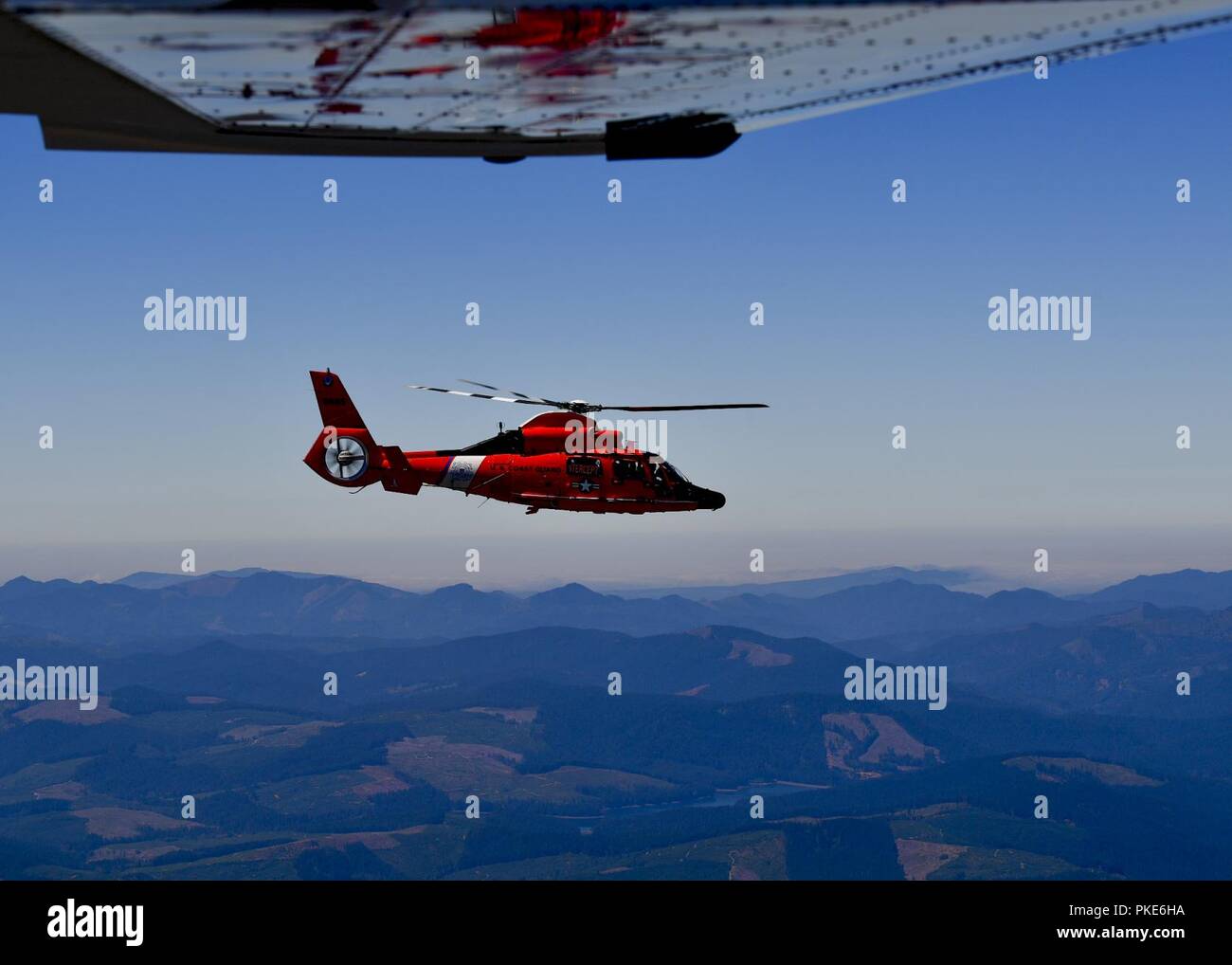 A U.S. Coast Guard HH-65 Dolphin intercepts a Cessna 182 Skylane during ...
