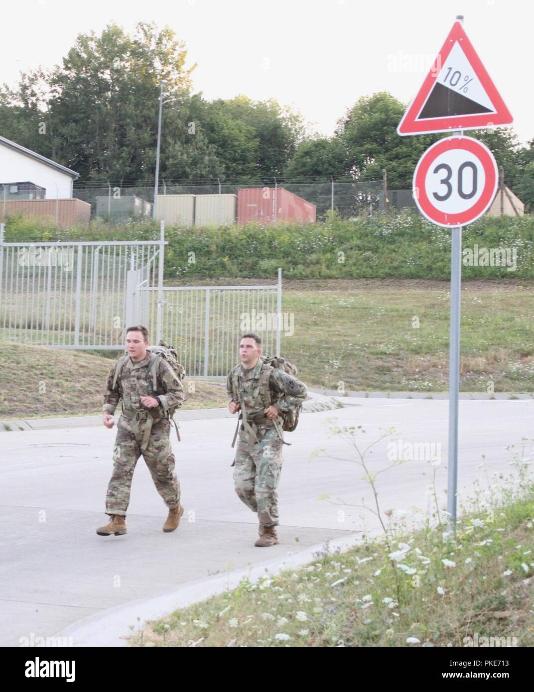 1st Lt. Benjamin Jones (right) conducts a road march with Sgt. David ...