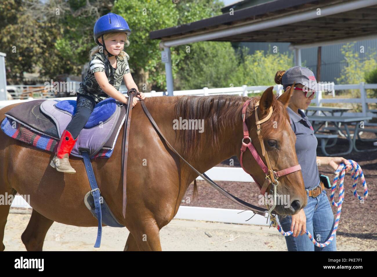 Tanaya Wilson (right), an employee for Stepp Stables, guides Temperance ...