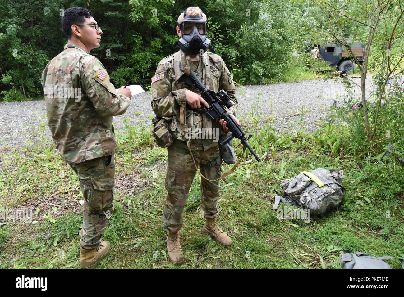 A U.S. Army medic (left) grades Spc. Calvin Furniss (right) from ...