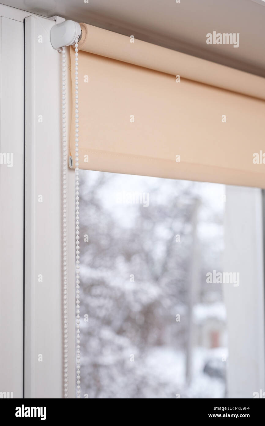 Beige blackout roller blind on the white plastic window. Shutters on ...