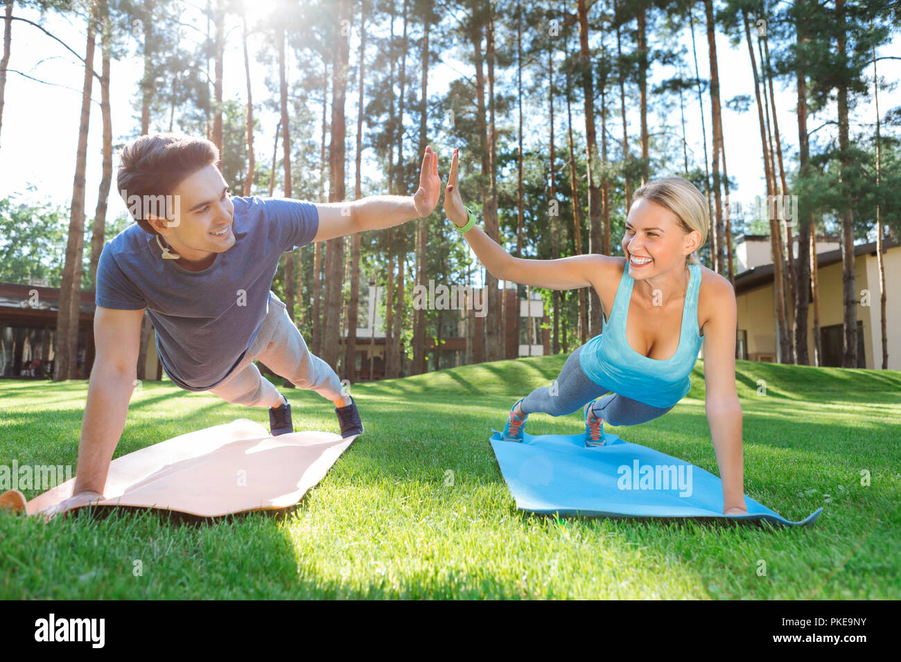 Joyful delighted people giving each other high five Stock Photo - Alamy