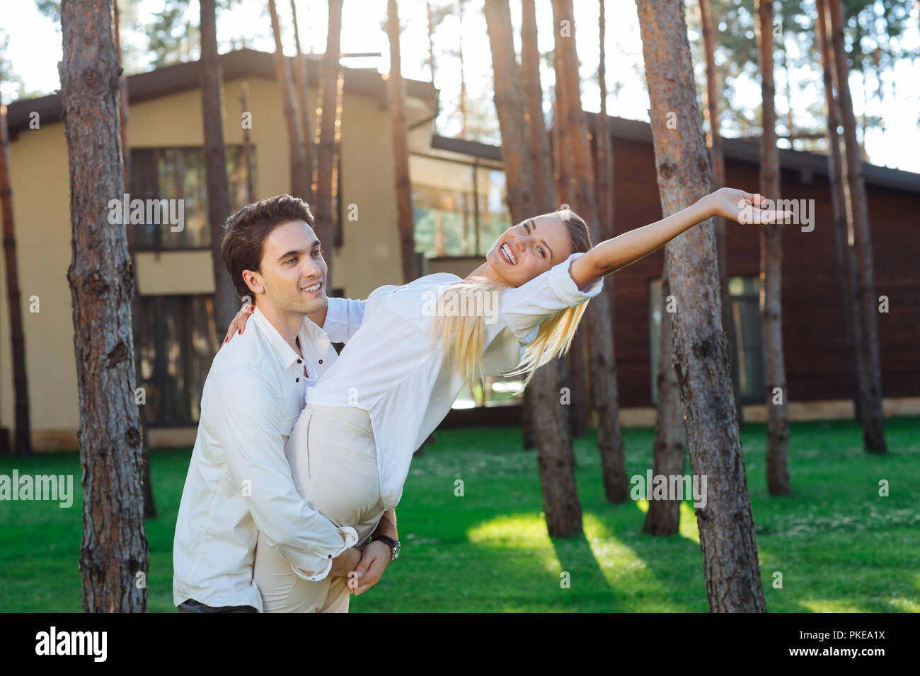 Nice delighted woman feeling safe and protected Stock Photo - Alamy